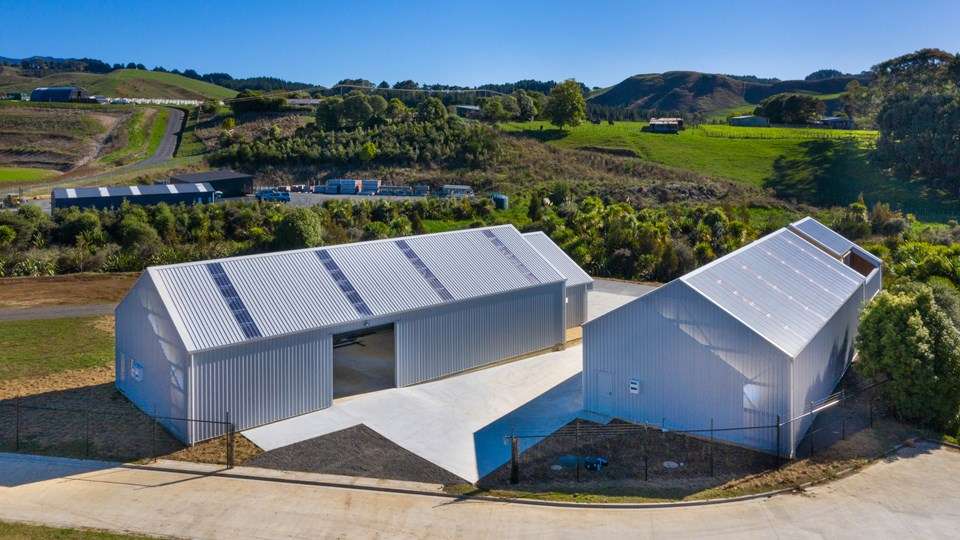 Industrial unit surrounded by water and extensive native planting ...