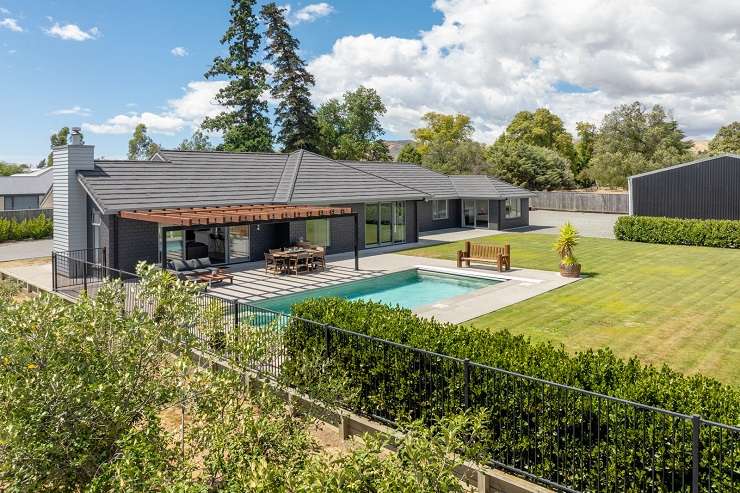 Auction room erupts after 83 frantic bids on lifestyle home push price ...